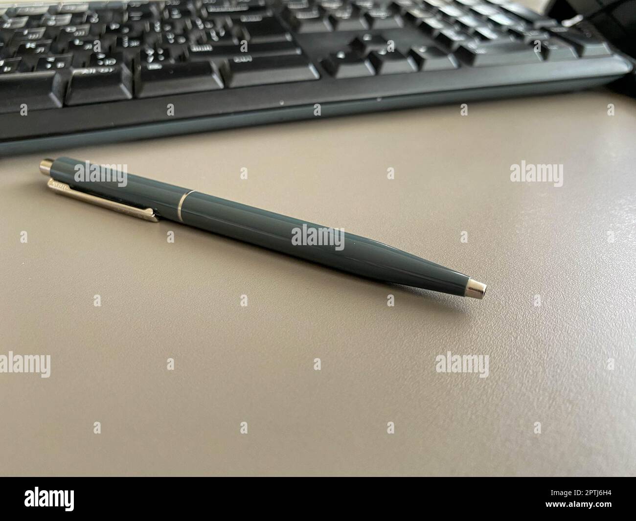Automatic green ballpoint pen for writing on desktop office desk with ...