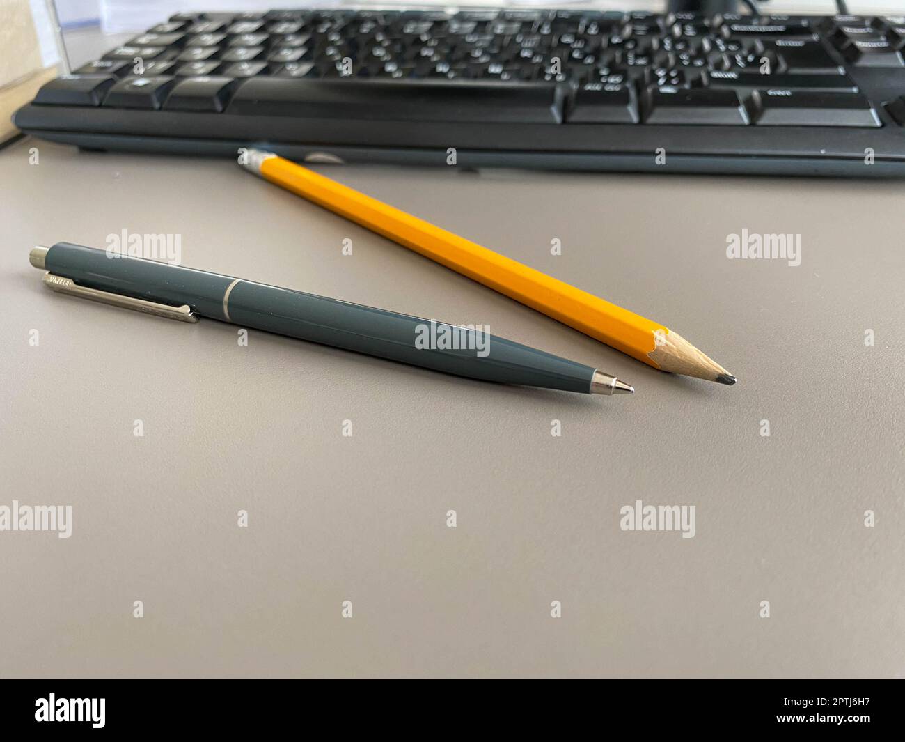 Automatic green ballpoint pen and writing pencil on desktop office desk ...