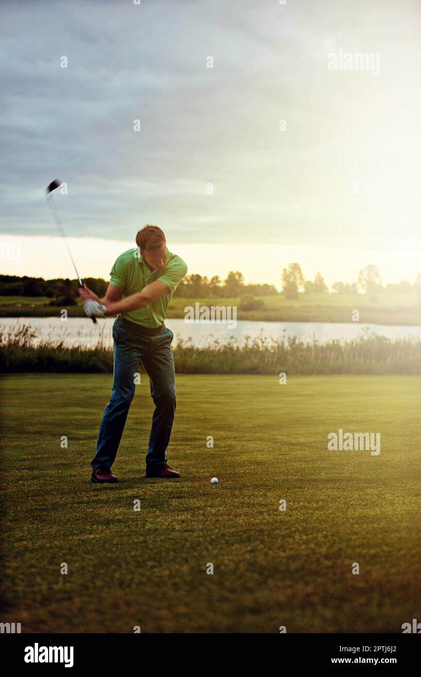 Its all in the form. a man practicing his swing on the golf course ...