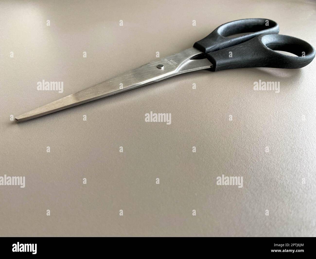 Black metal sharp scissors for paper on the working office table ...
