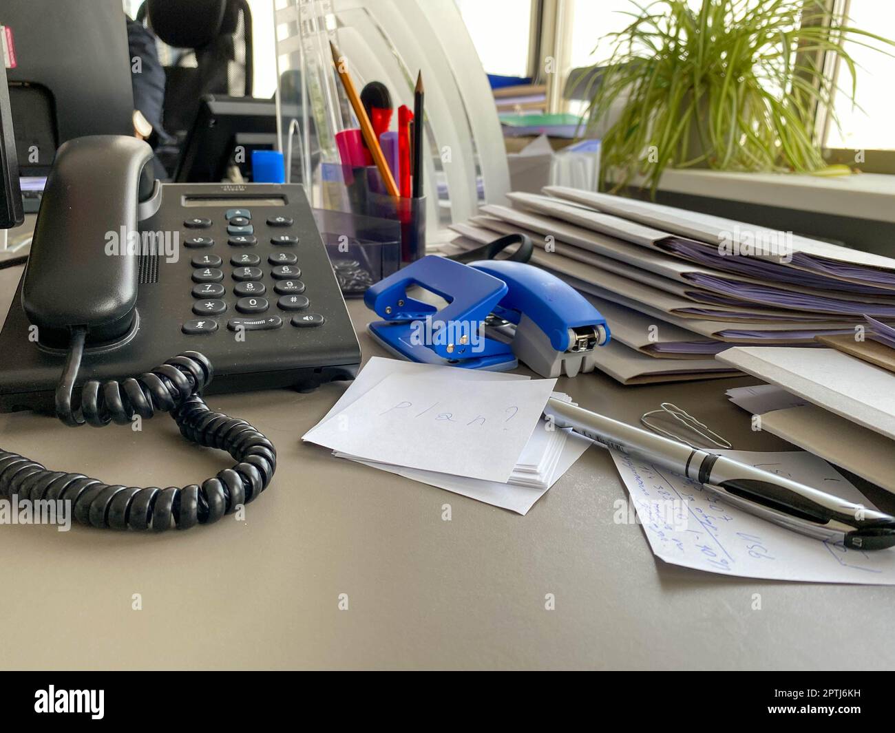 Black landline telephone with a tube, buttons and a wire on the work ...