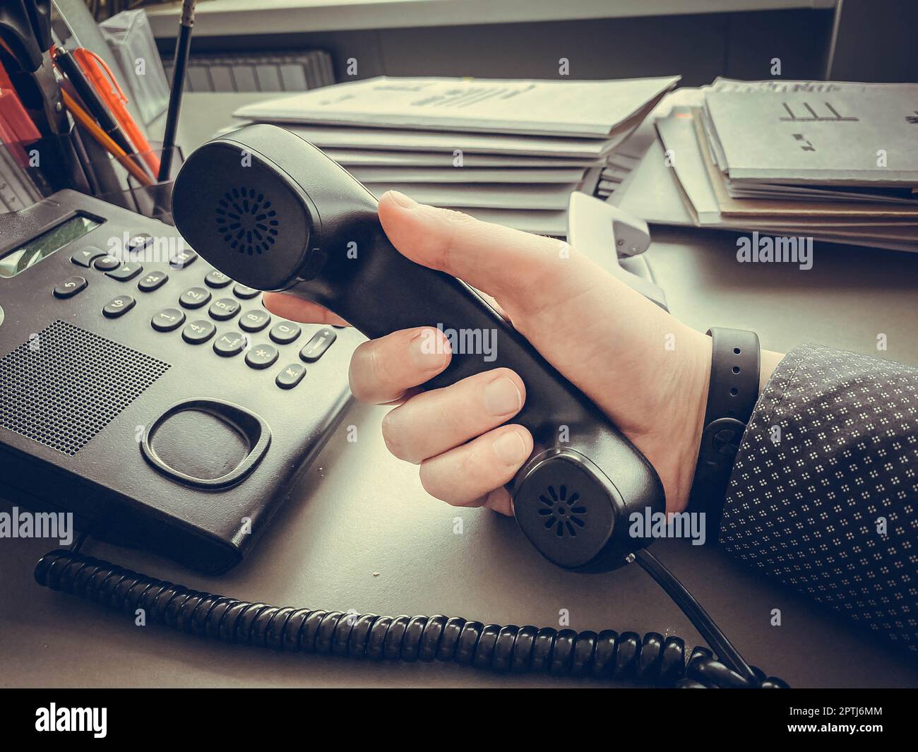 Closeup Of Businessman Holding Handset Of A Black Landline Telephone ...