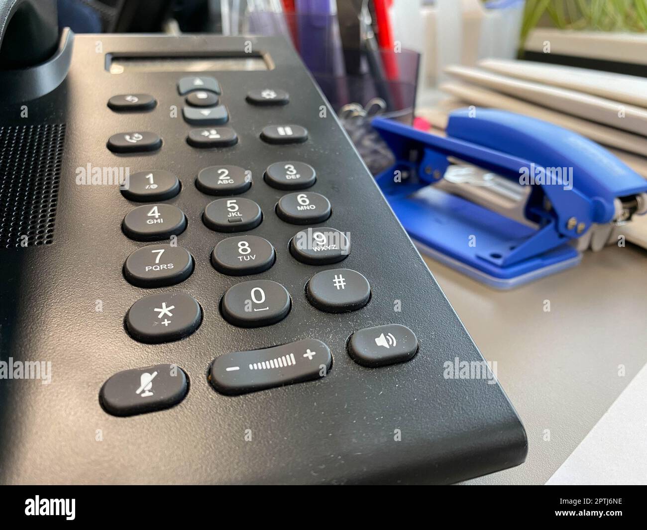 Black plastic office landline corded telephone with a handset and ...