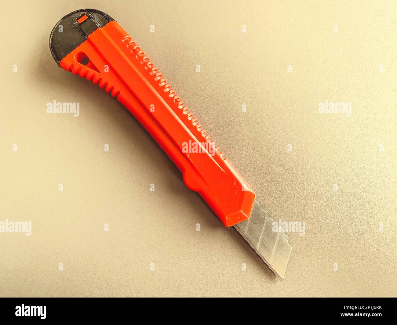 stationery on the table in the office. stationery knife with a red ...