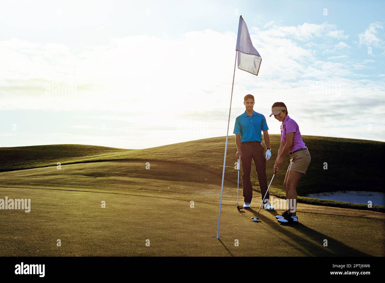 Partners on and off the fairway. a couple playing golf together on a ...