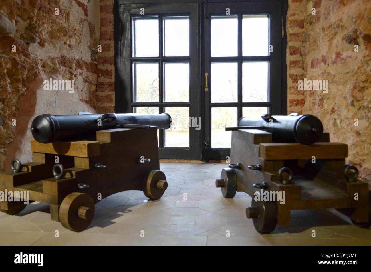 Two large powerful old medieval cannons facing the window Stock Photo ...