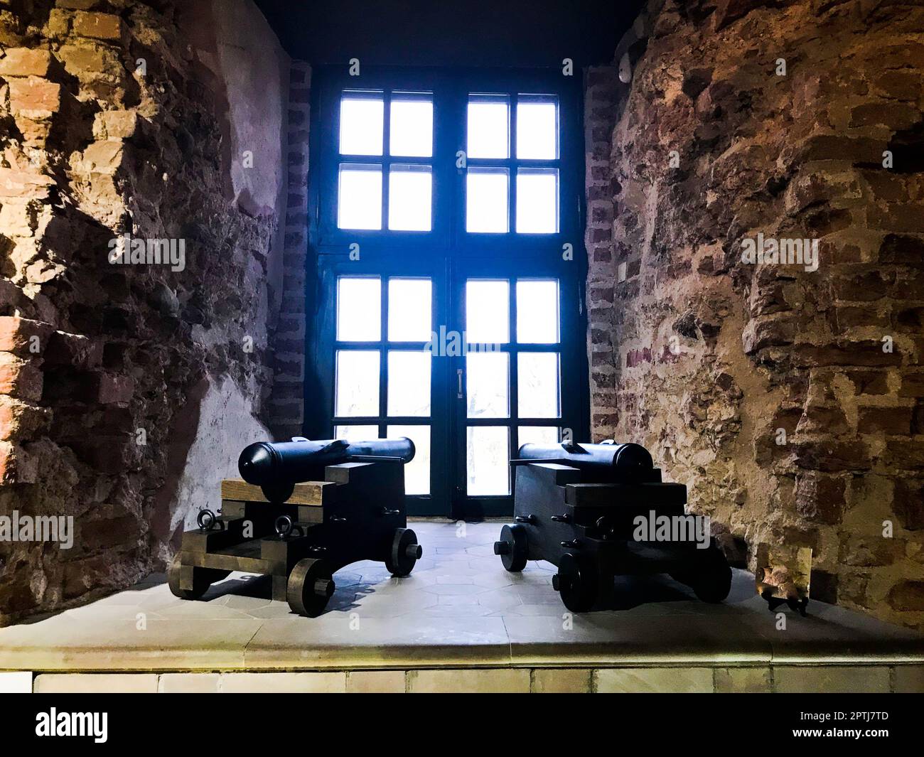 Two large powerful old medieval cannons facing the window Stock Photo ...