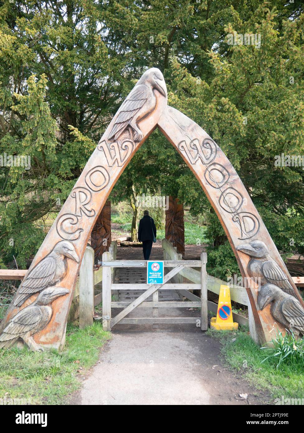Carved wooden arch at the entrance to Crow Wood an area of woodland for ...