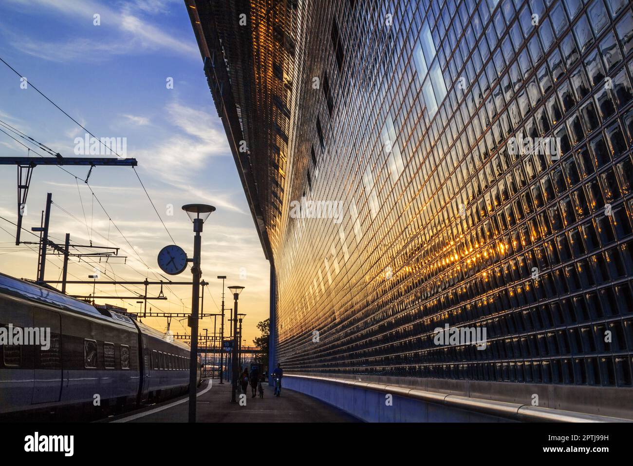 Railway station at the golden hours with afterglow reflected on glass ...