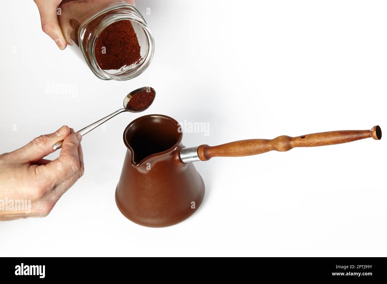 Men's hand holding spoon with coffee powder isolated white background ...