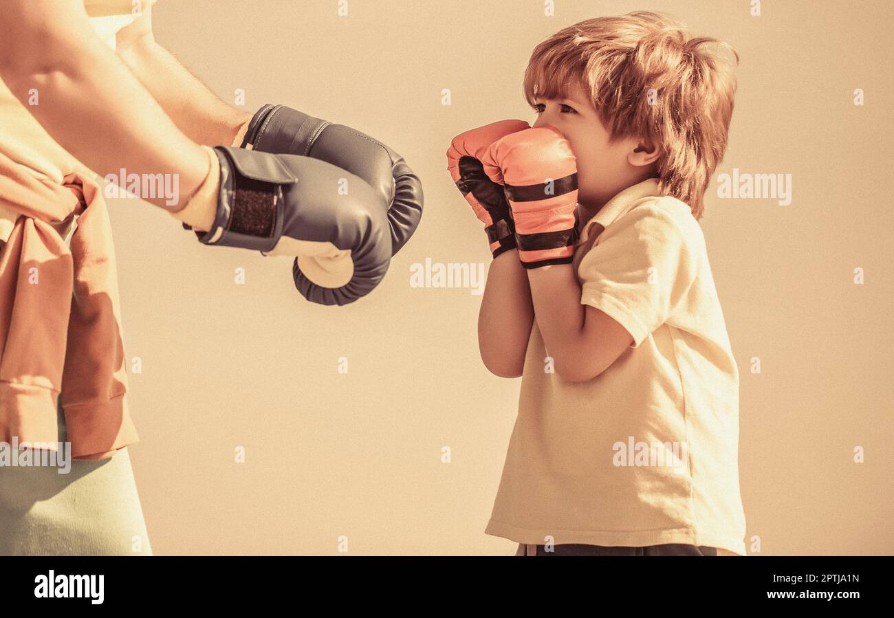 Little boy doing boxings exercise with grandfather. Father is training ...