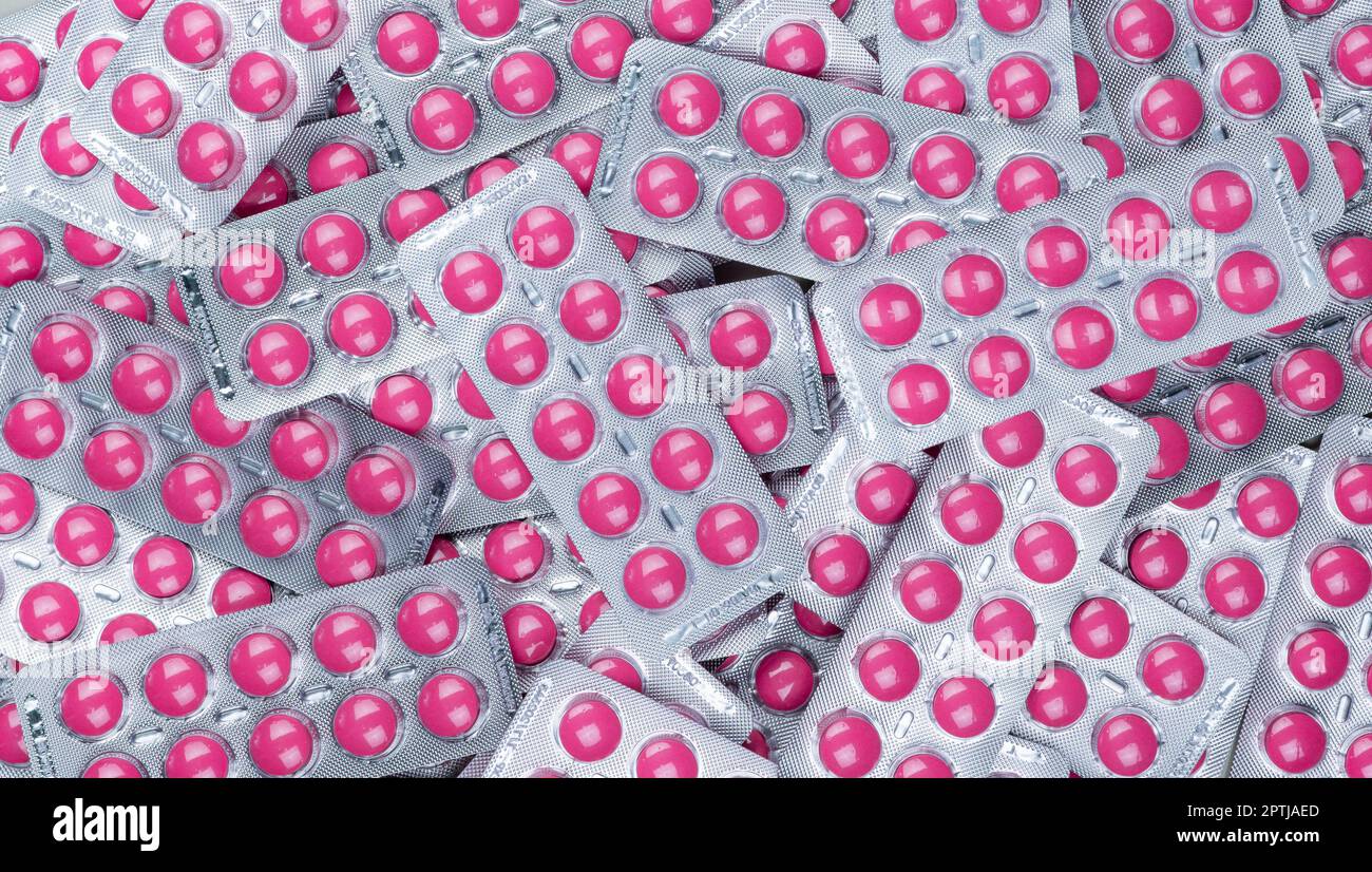 Full frame heap of round pink tablets pills in blister pack ...
