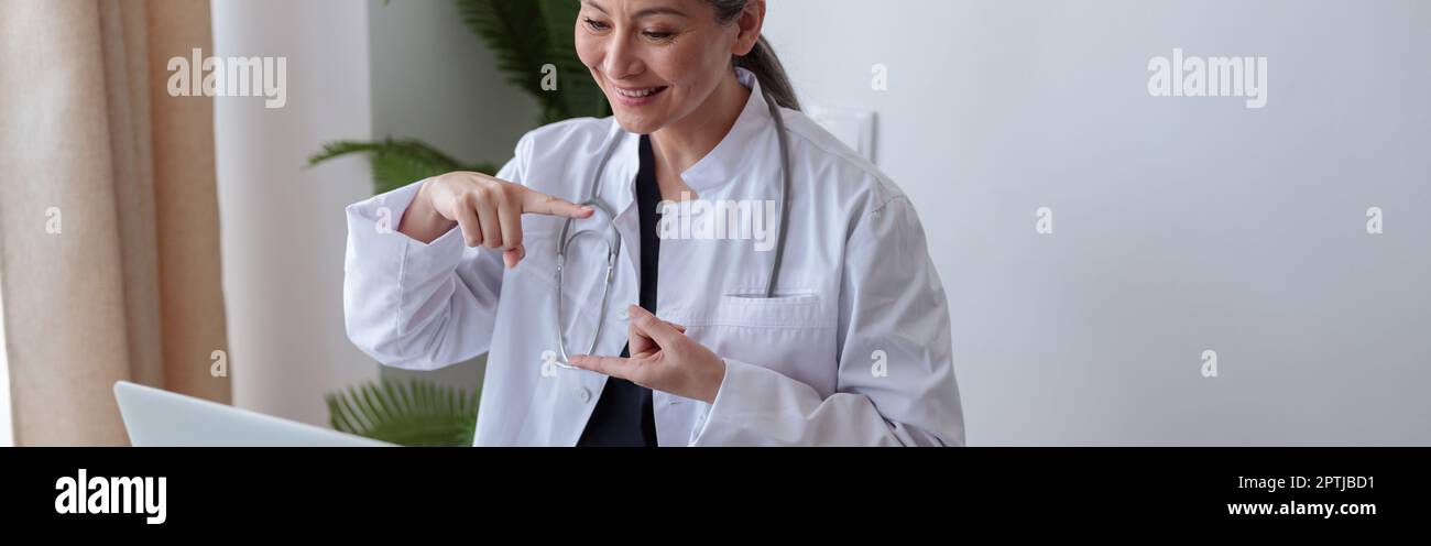 Woman doctor communicating with patient using sign language Stock Photo ...