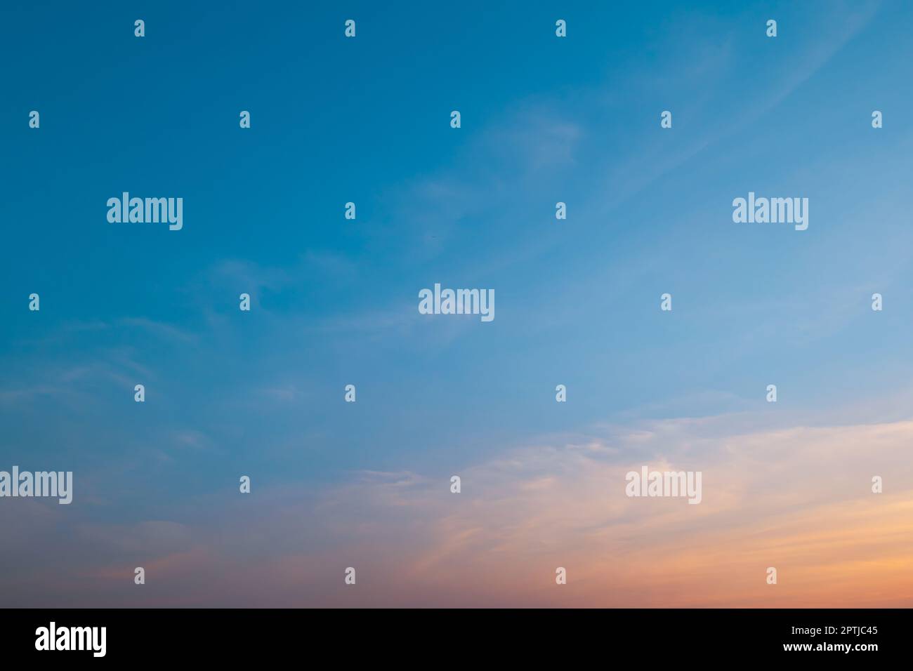 Bright orange sunset sky background with gentle colorful clouds, soft ...