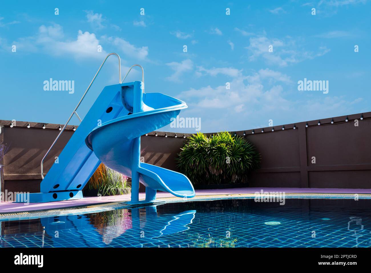swimming pool with slides over blue sky background. summer concept ...
