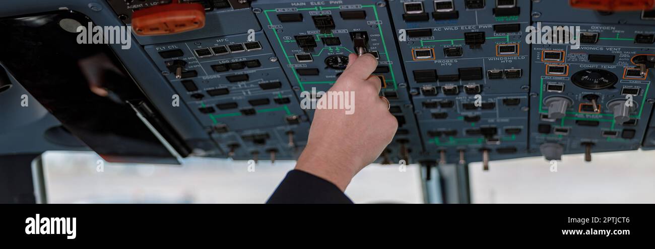 Aircraft pilot operating overhead panel of airplane flight deck Stock ...