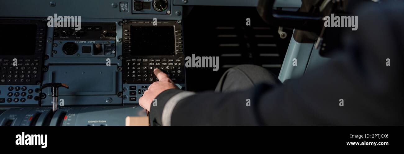 Airline pilot using instrument panel in aircraft cockpit Stock Photo ...