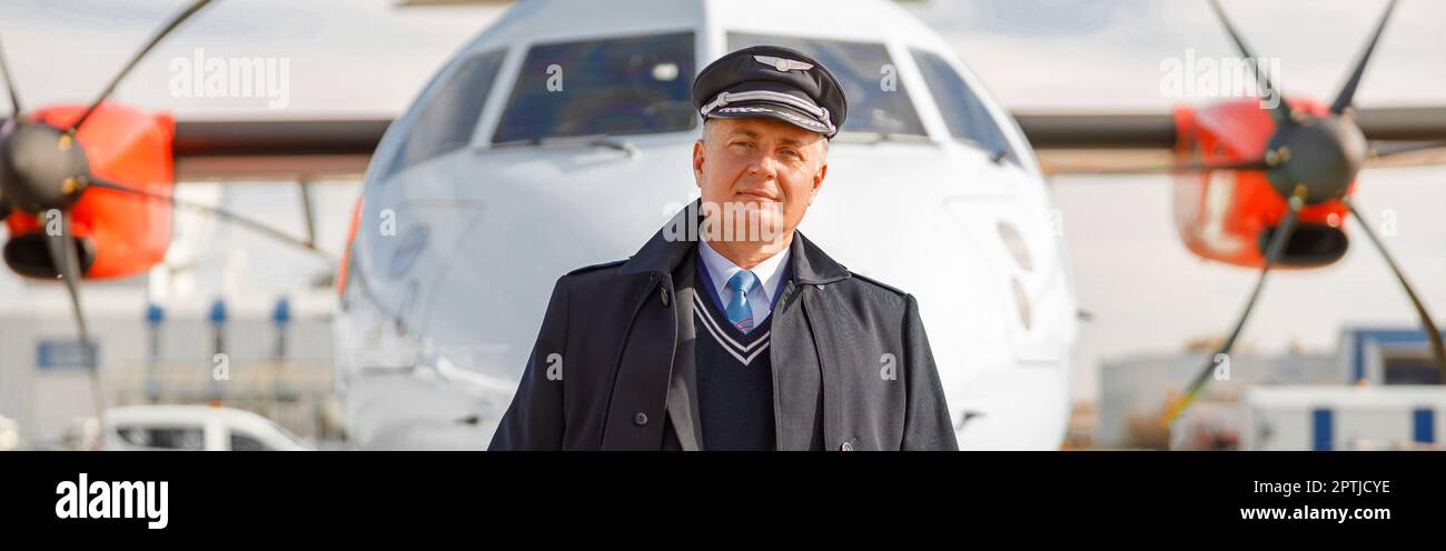 Airline captain in aviation uniform standing outdoors at airport Stock ...