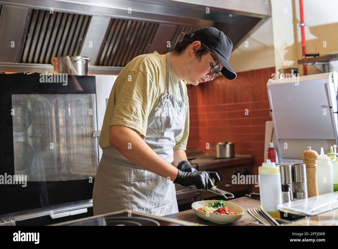 Professional chef grates Parmesan cheese on ready dish in restaurant ...