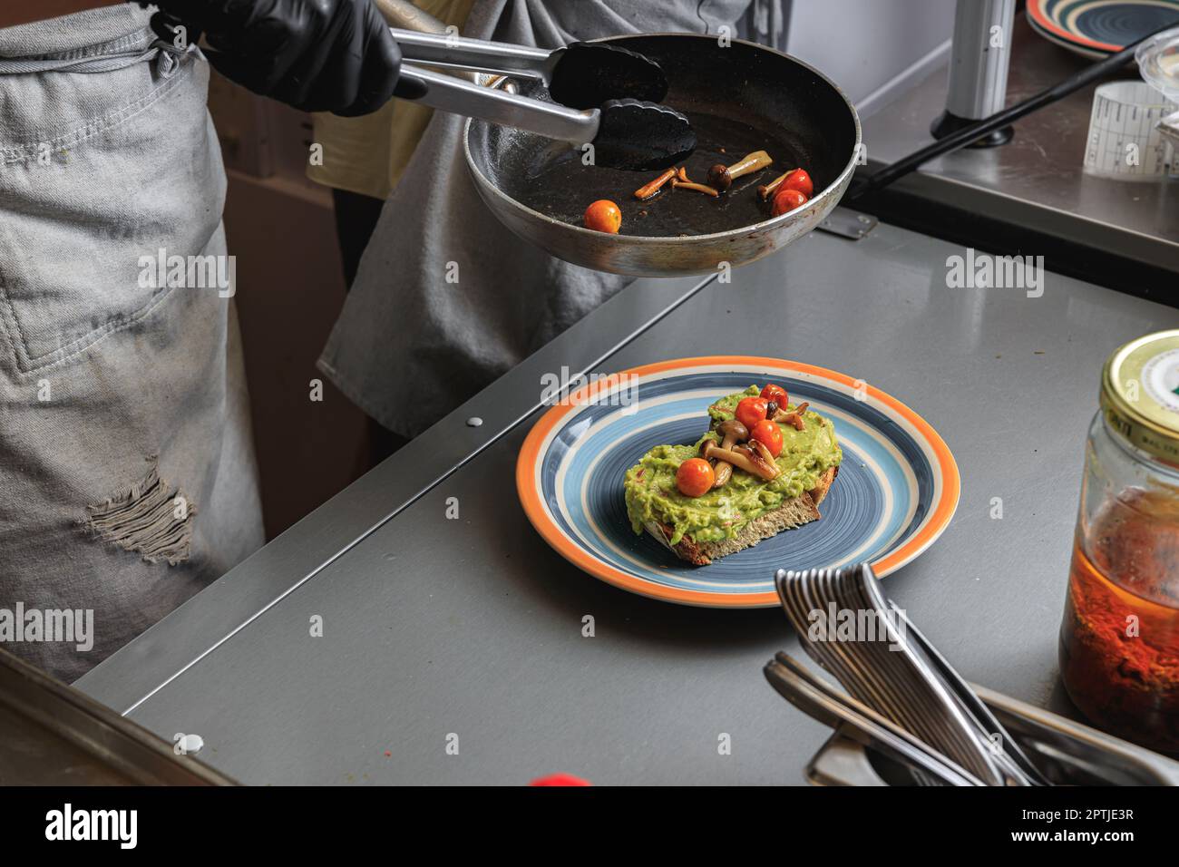 Chef hands cooking avocado toast with vegetables for breakfast menu in ...