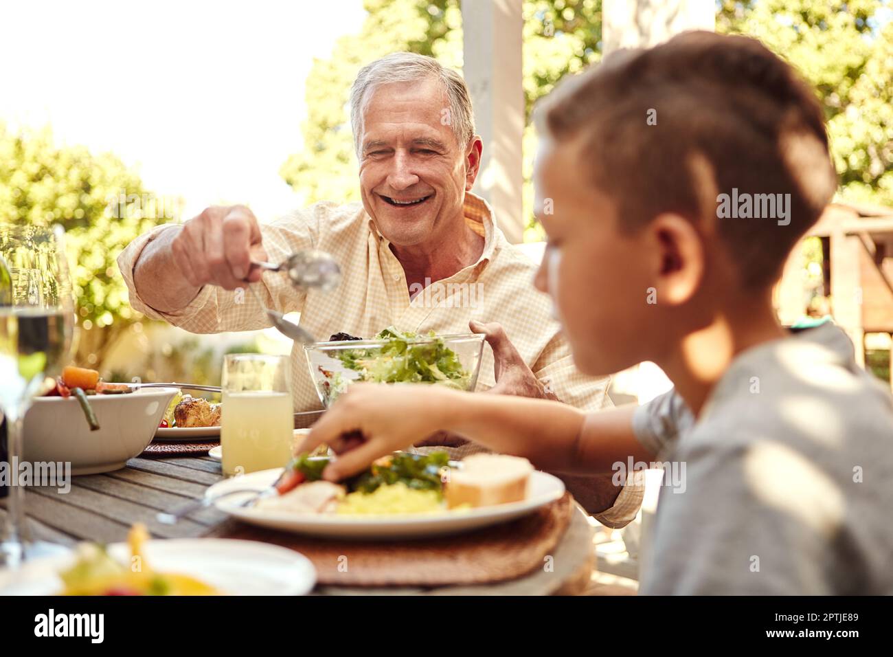 Laid back Sunday lunch with the family. a family eating lunch together ...