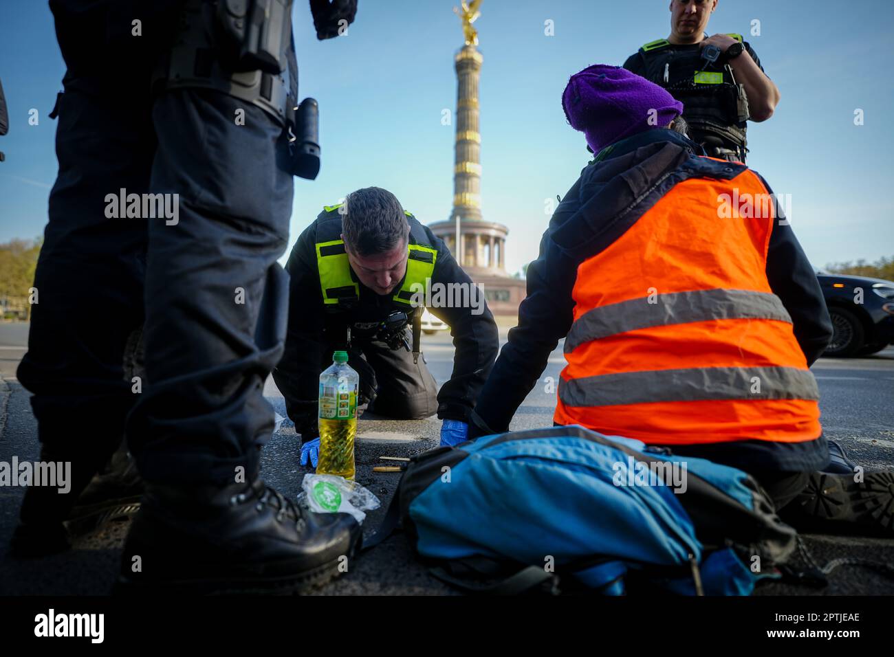 Berlin, Germany. 28th Apr, 2023. A police officer removes the hand of a ...