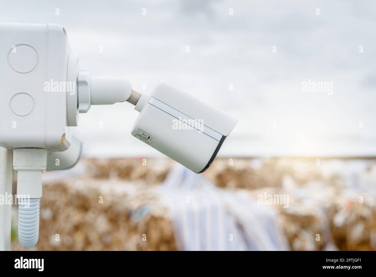 Side view of white CCTV security camera video system for safety at a ...