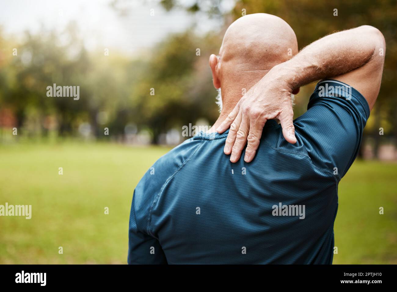 Exercise, fitness and back pain of senior man at outdoor park after bad ...