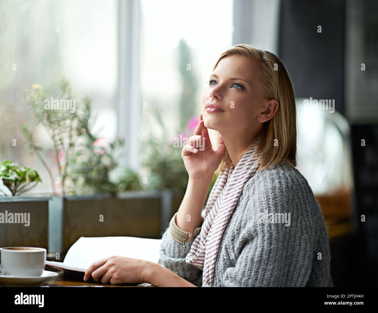 Everyone needs a place to just unwind. a beautiful young woman sitting ...