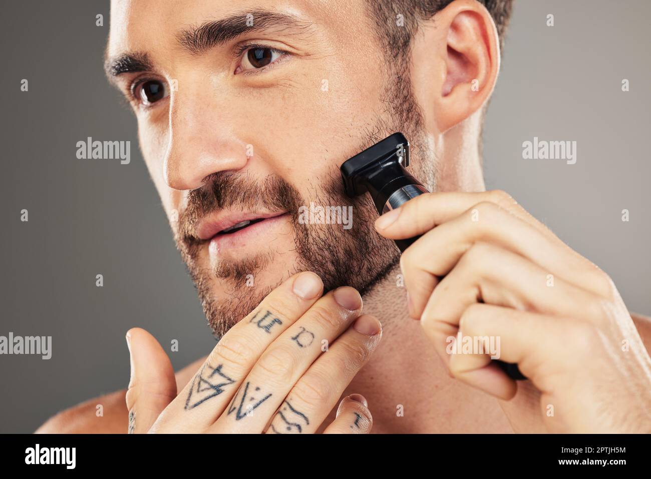 Shaver, beard and man grooming in a studio for beauty, hygiene and ...