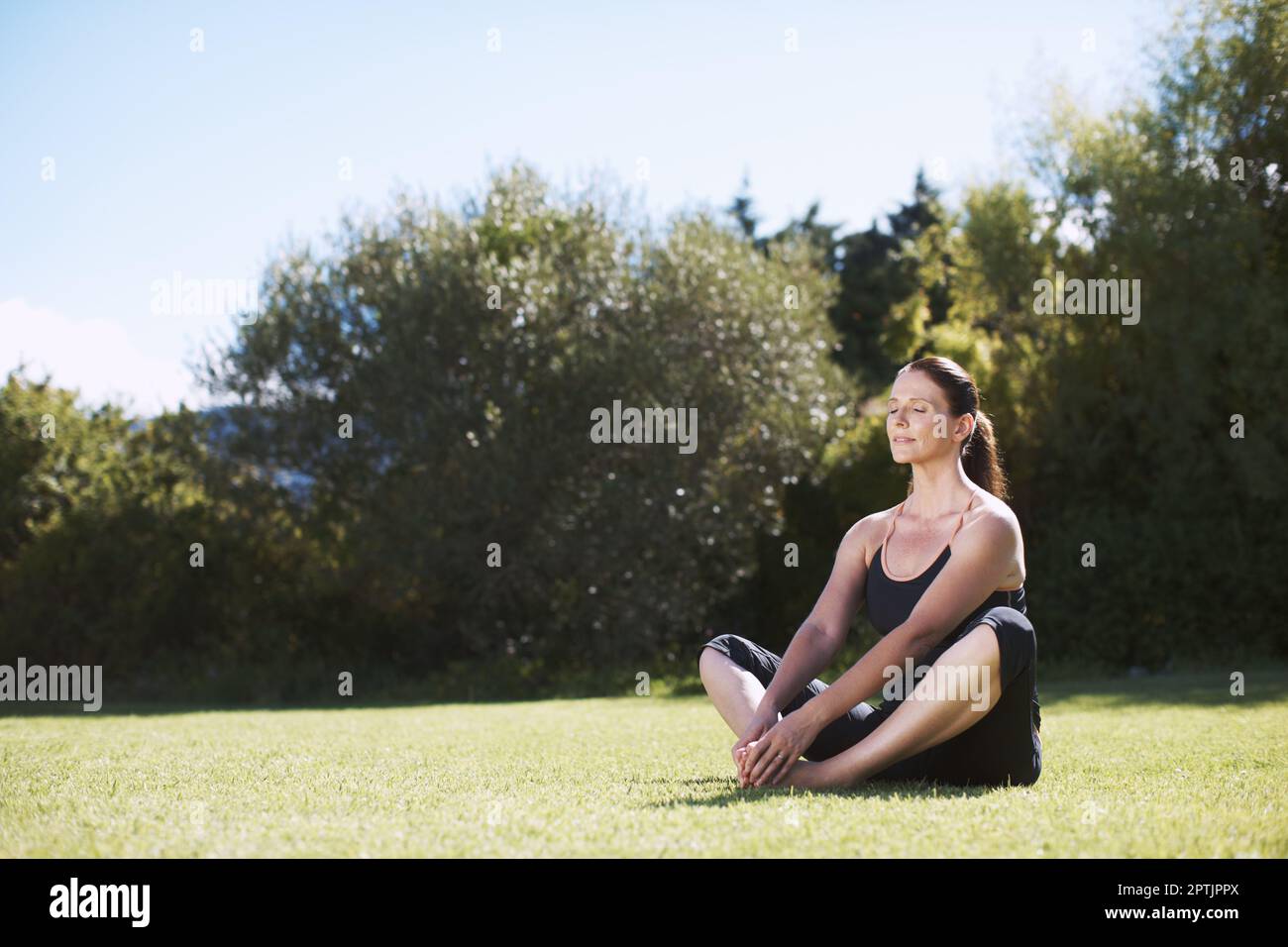 The importance of being mindful. An attractive woman sitting on the ...