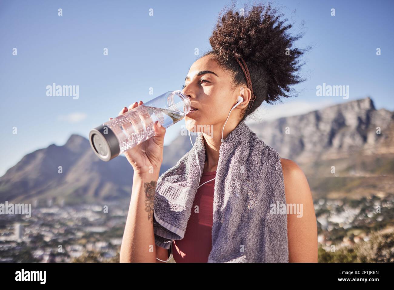 Fitness, wellness and black woman drinking water in nature after ...