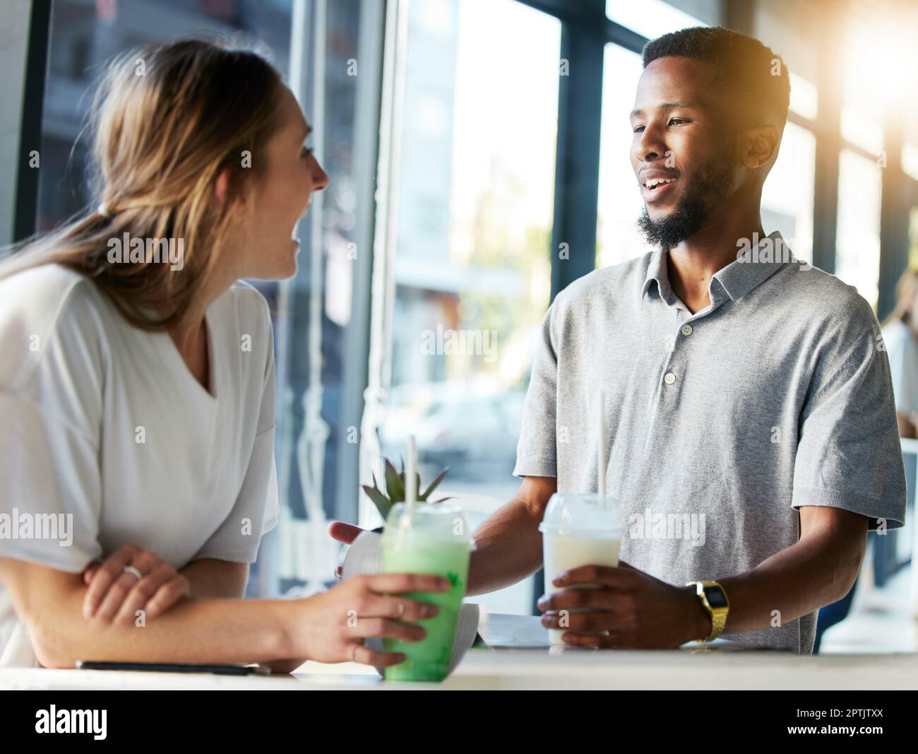 Restaurant, date and couple drinking milkshake while talking, bonding ...
