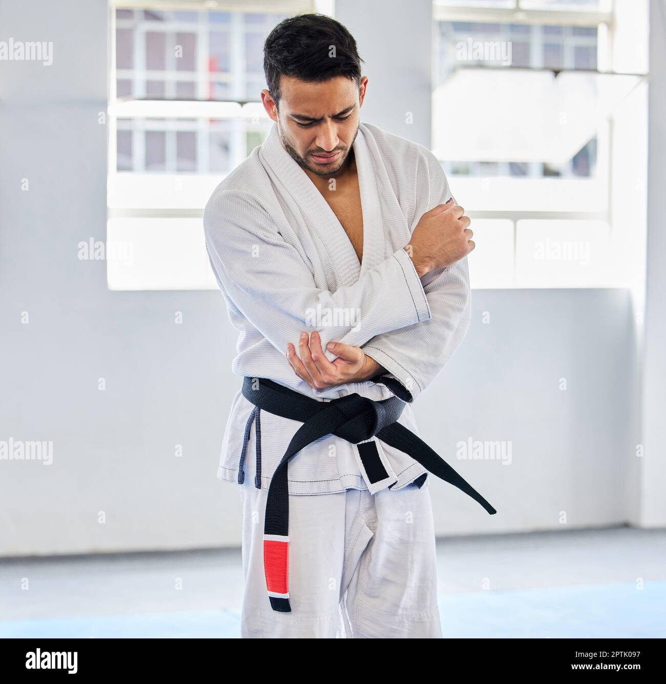 Karate, arm pain and man with injury in dojo, healthcare and fighting ...