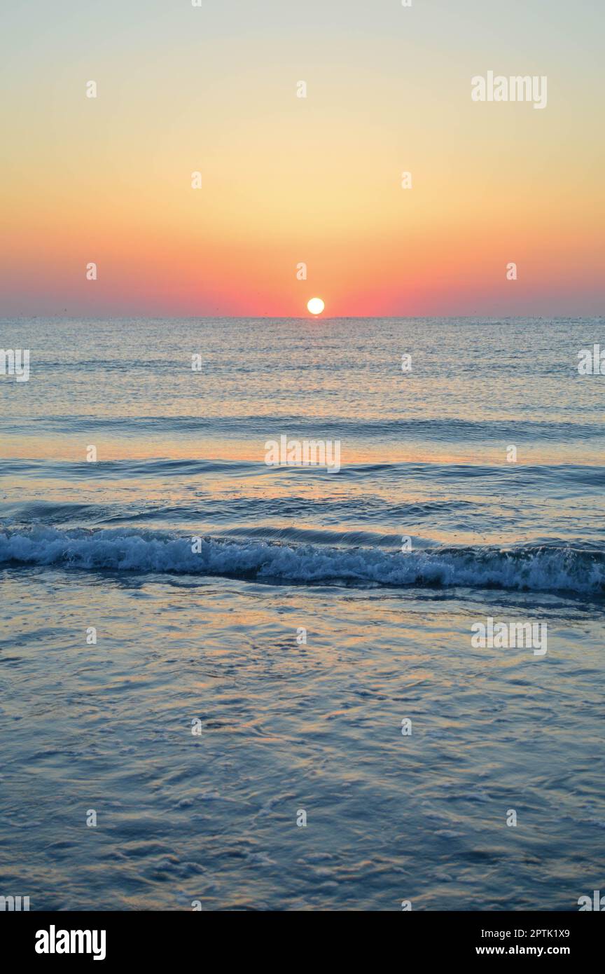 Beautiful summer landscape, sunset at the beach, sparkly sand and waves ...