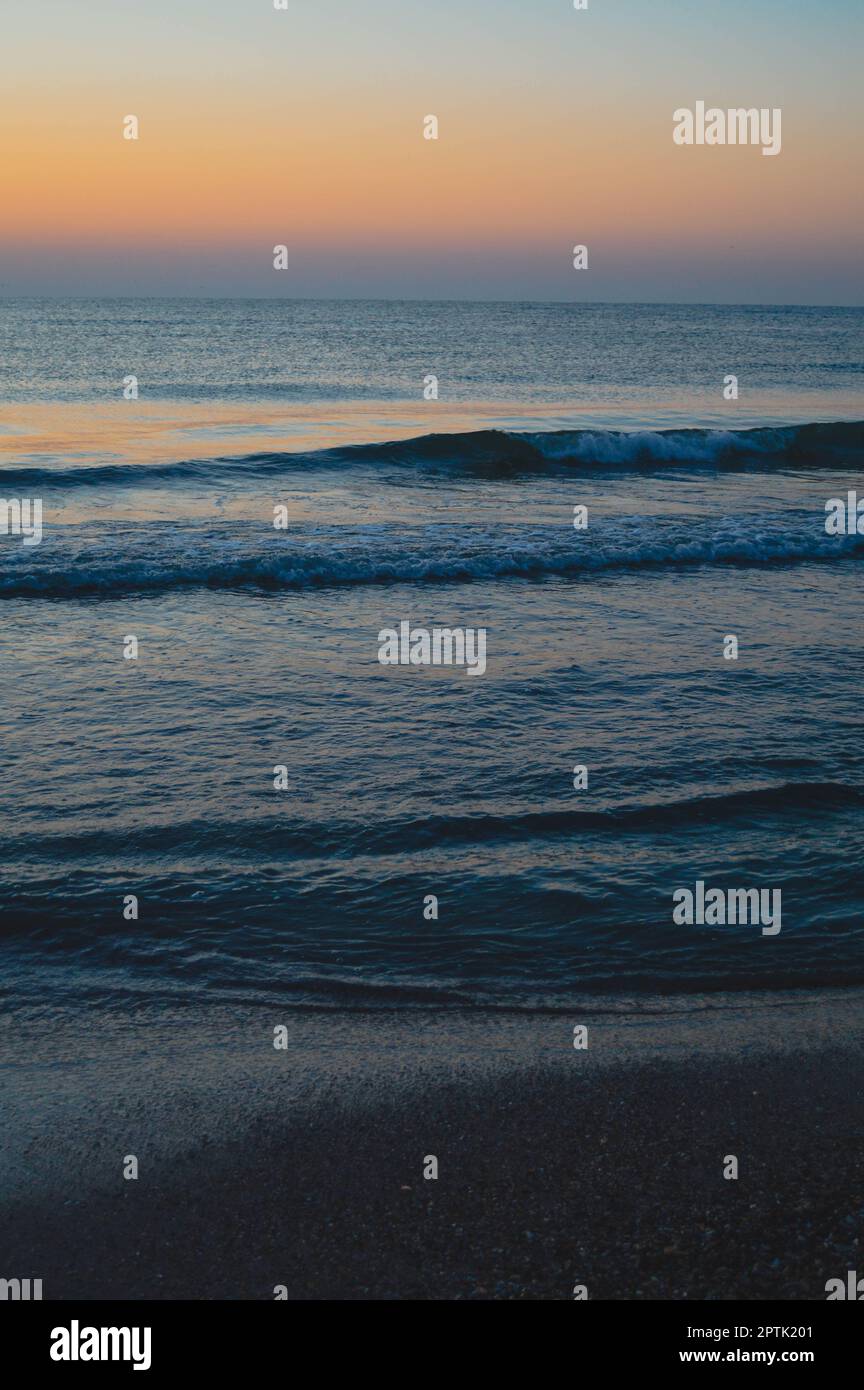 Beautiful summer landscape, sunset at the beach, sparkly sand and waves ...