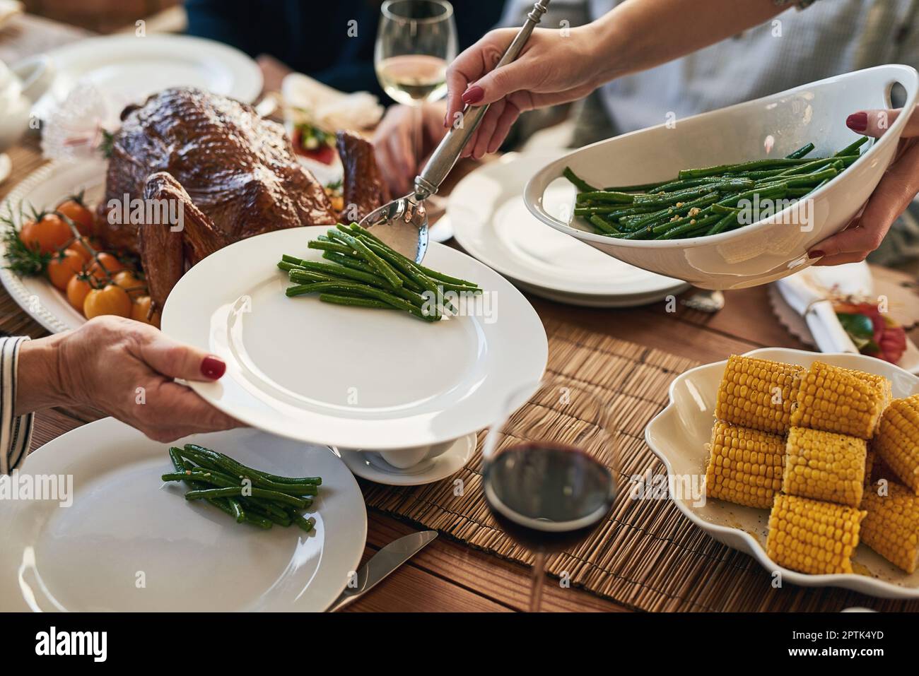 Hands, food and family at a table for thanksgiving, eating and bond on ...