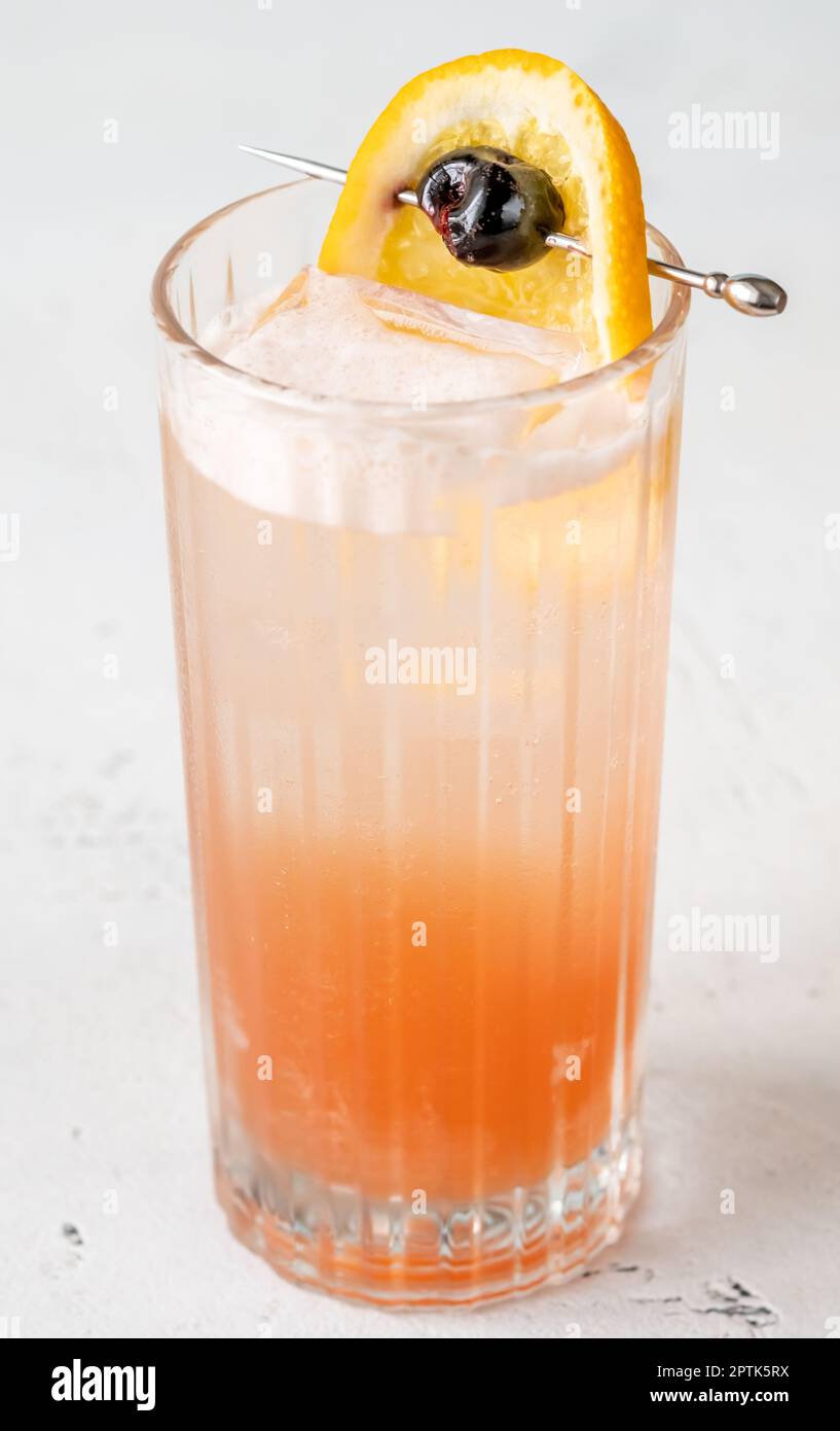 Singapore Sling cocktail garnished with orange wheel and cherry Stock ...