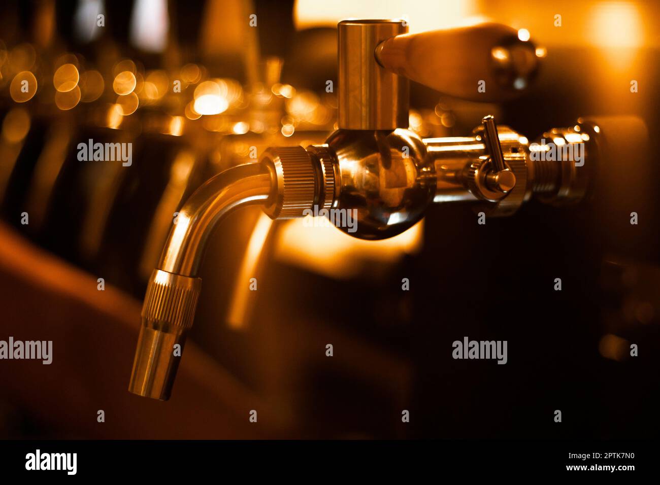 Creatively blurred image of faucets in beer pub with defocused bokeh ...