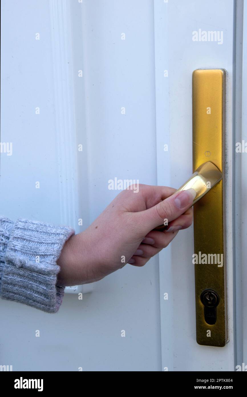 Woman opens door using hand Stock Photo - Alamy