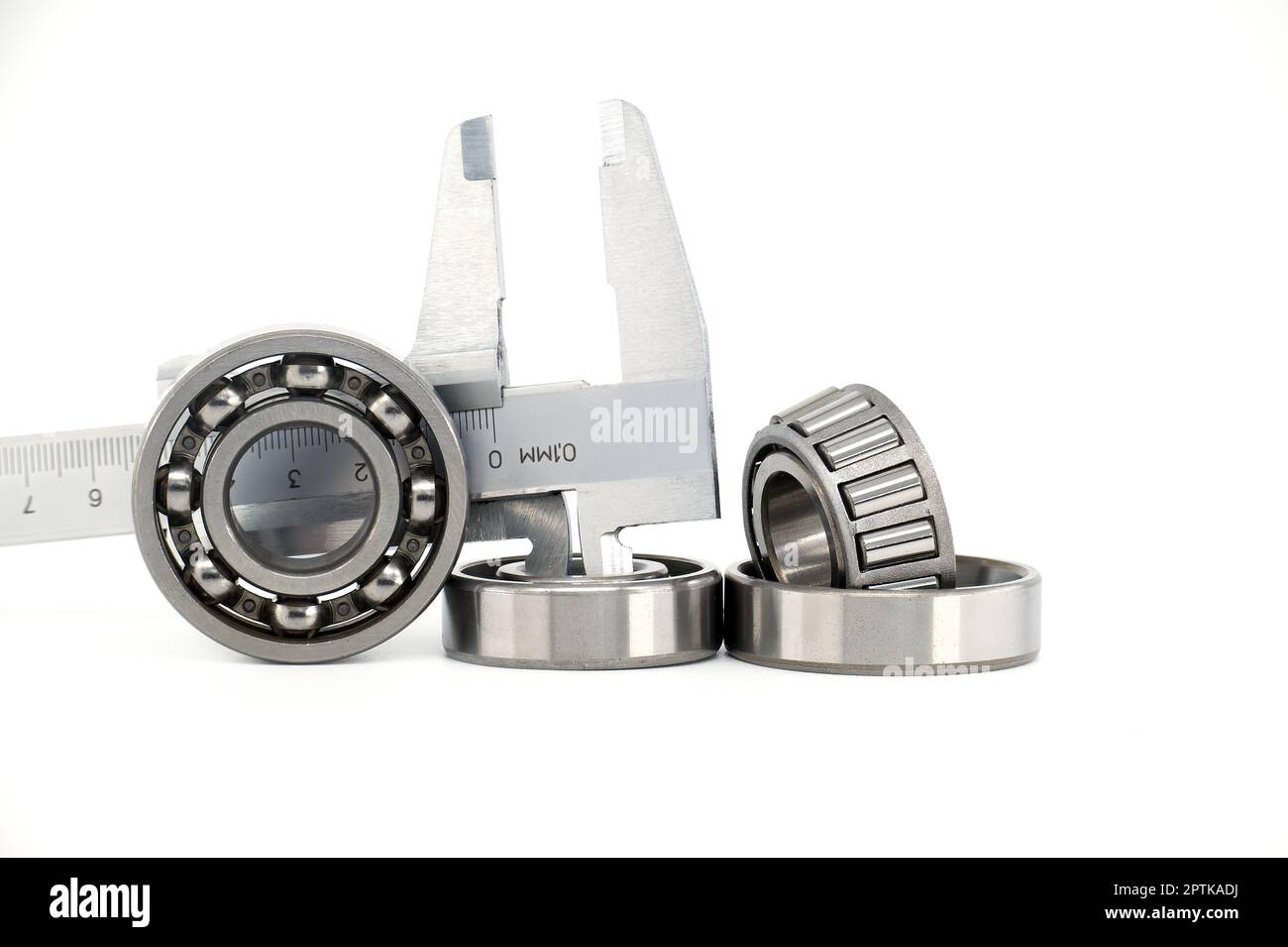 Measure caliper and roller bearings on white background. Mechanical ...