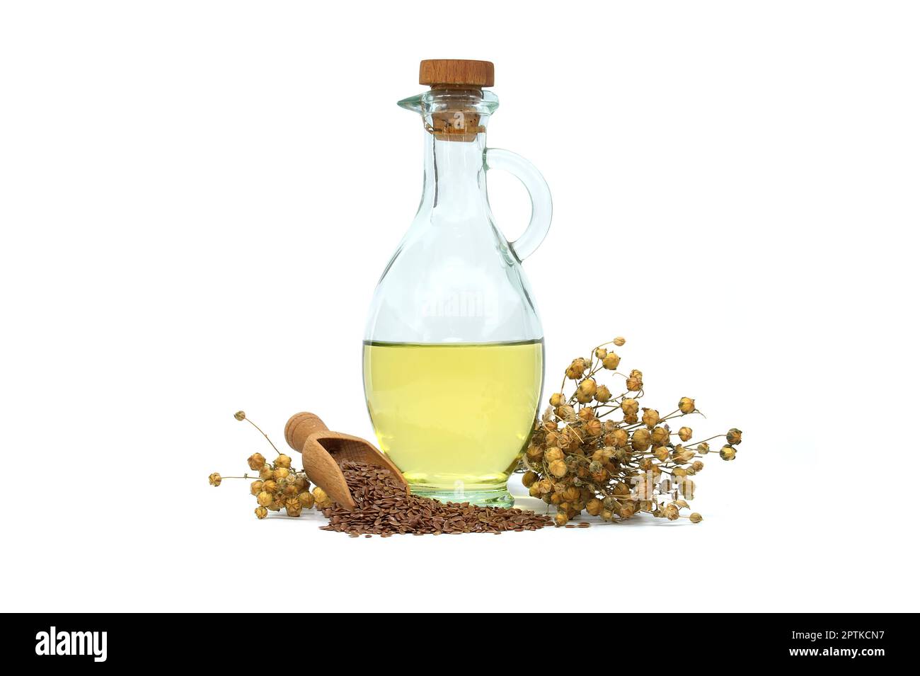 Linseed oil in glass decanter and linseed in wooden scoop near bunch of flax plants isolated on ...