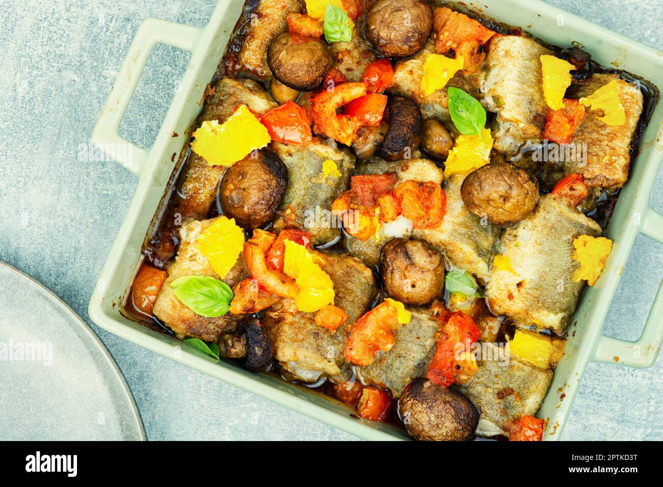 White fish hake cooked with mushrooms in the oven dish Stock Photo - Alamy