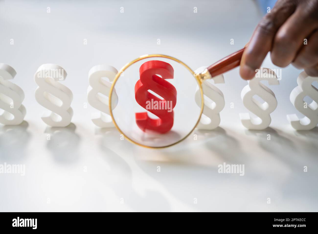 Close-up Of Businessman's Hand Looking Red Paragraph Sign With ...