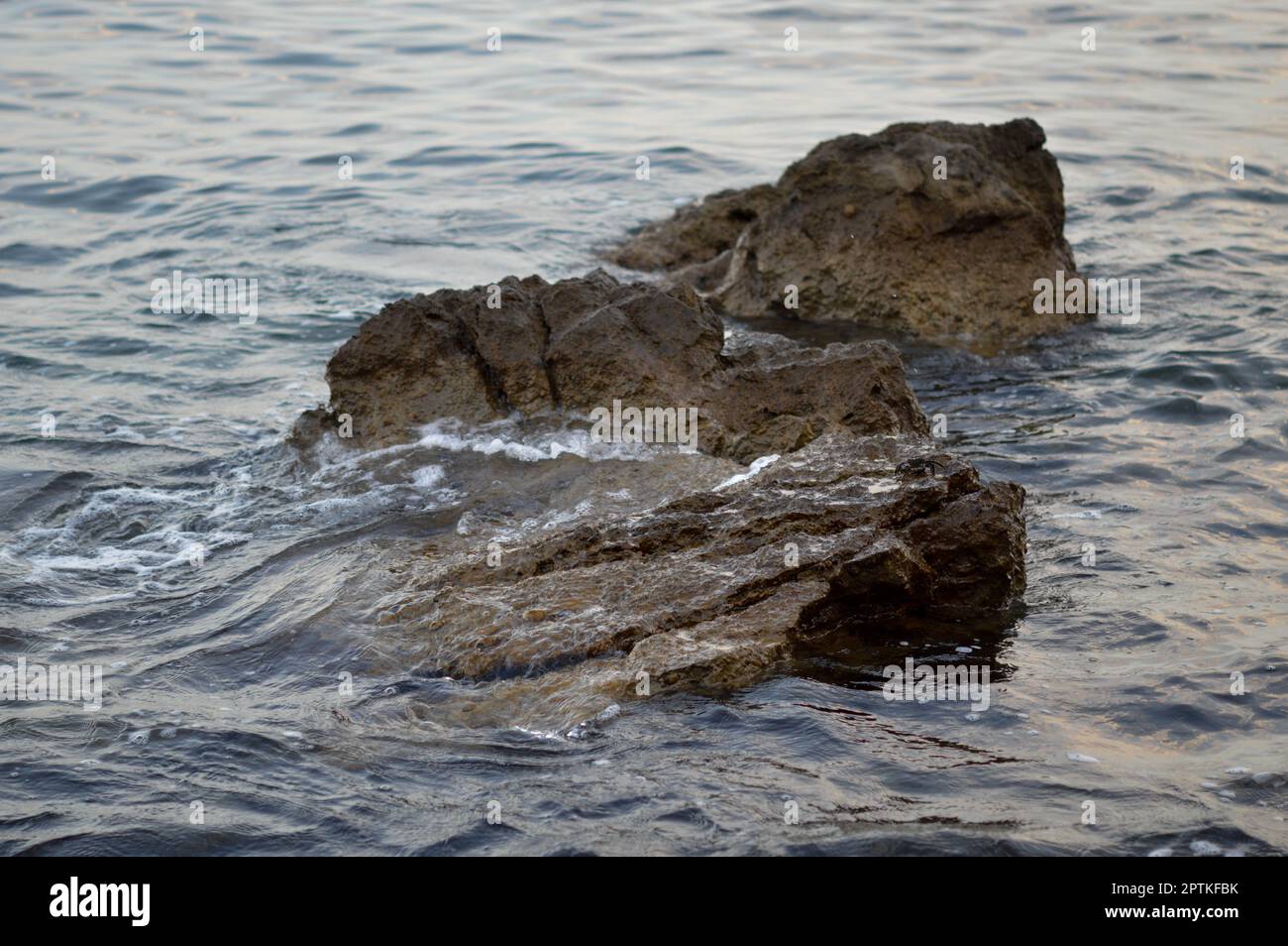 Rocks at the beach, calm water, small waves, clear water Stock Photo ...