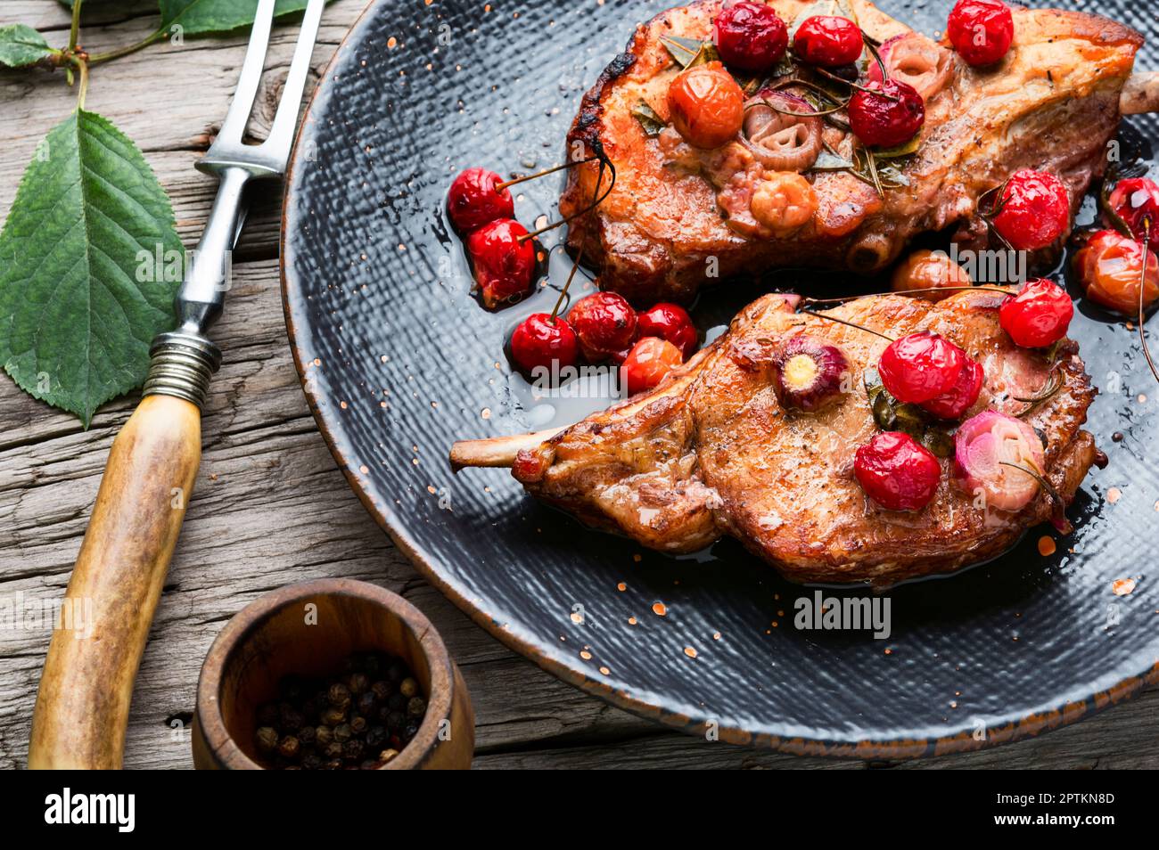 Delicious meat chops stewed in cherry sauce Stock Photo - Alamy