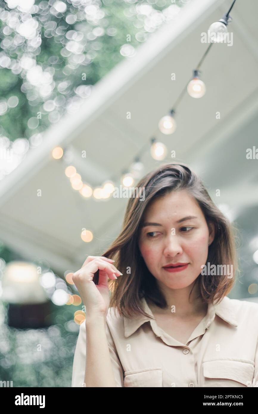 Women standing under the lights hanging to decorate the place Stock ...