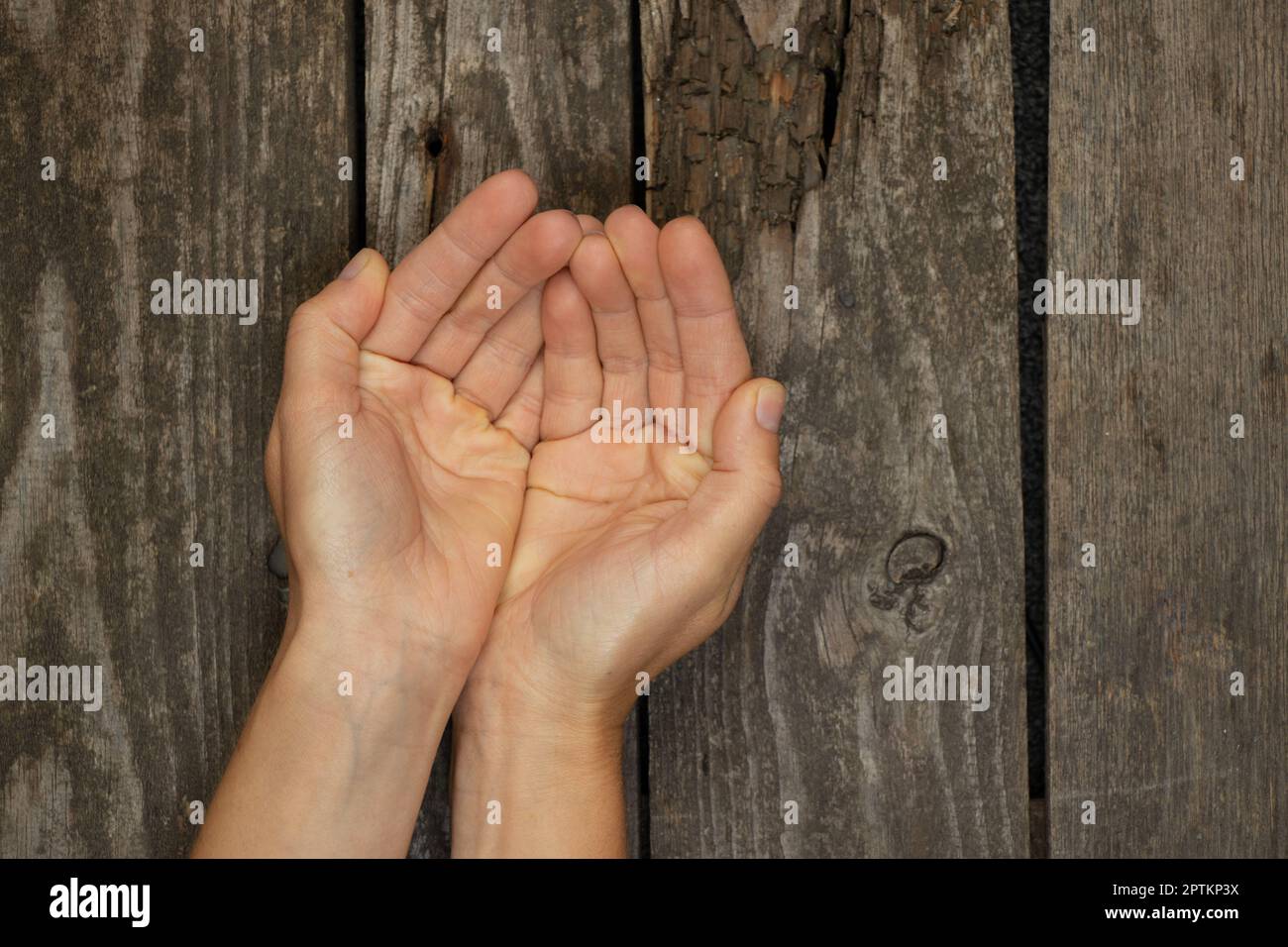 female palms on wooden background closeup Stock Photo - Alamy