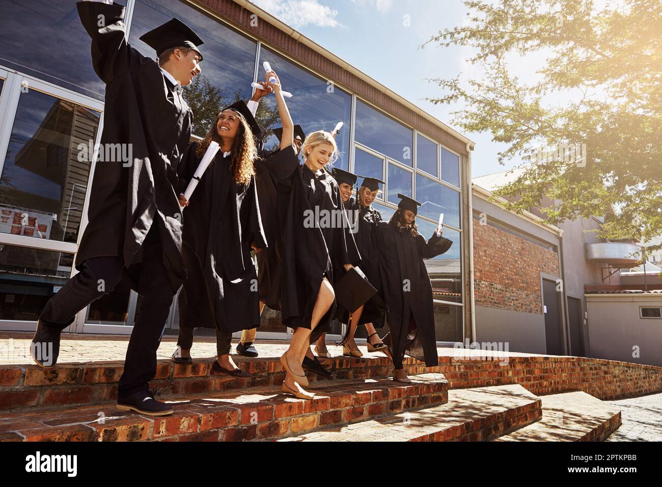 Celebrating their achievements together. a group of smiling university ...