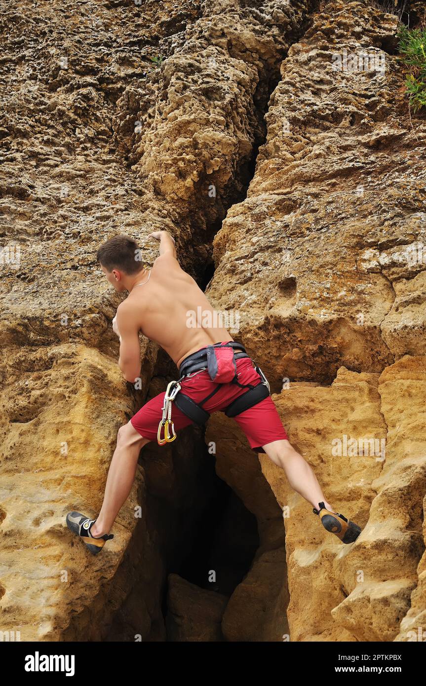 Man climbing on rocky hi-res stock photography and images - Alamy